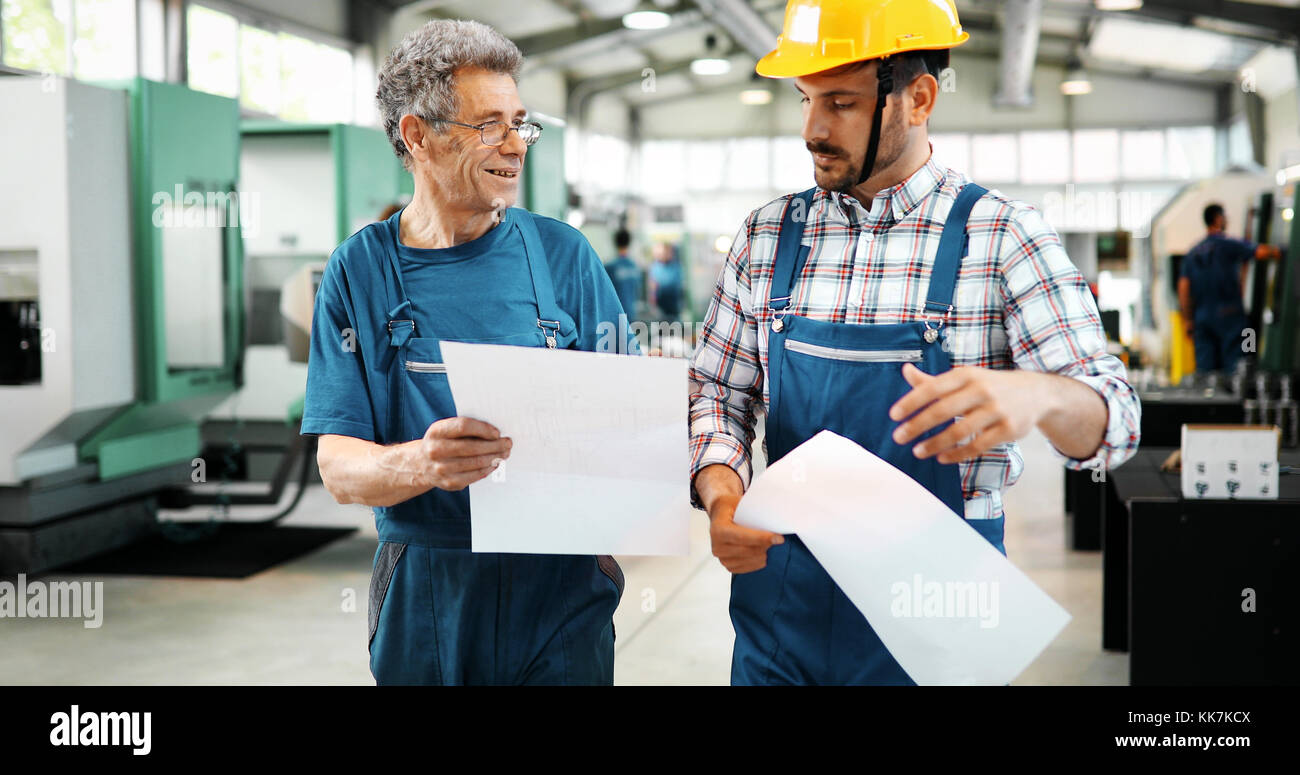 Team Of Engineers Having Discussion In Factory Stock Photo - Alamy