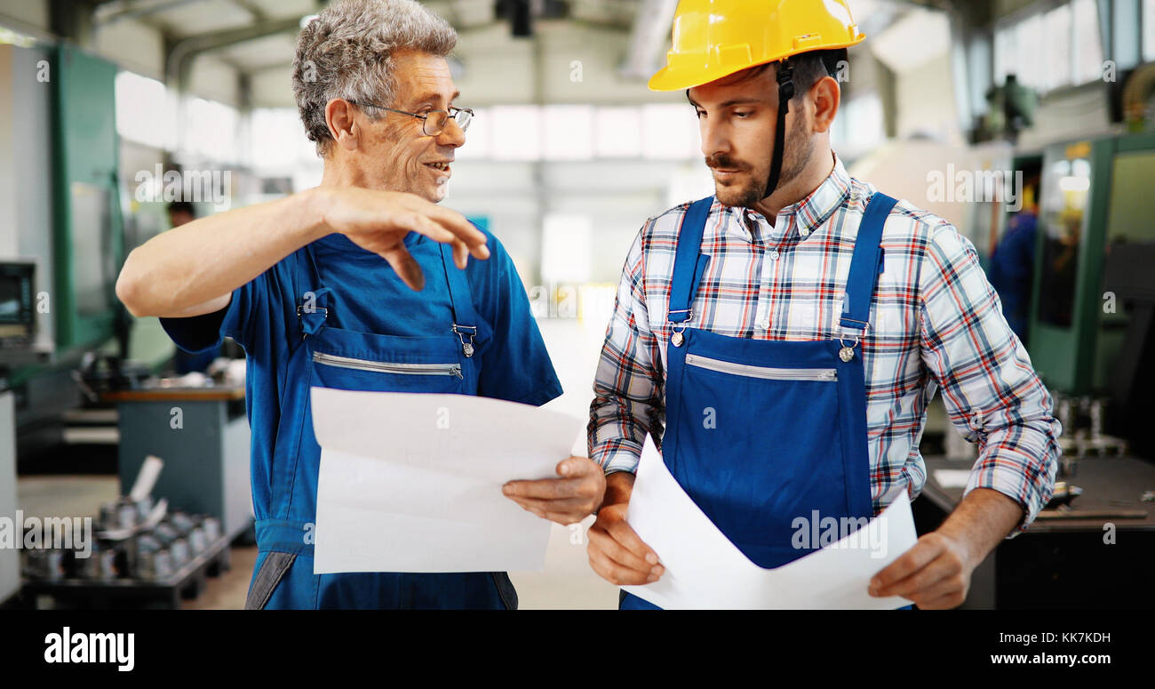 Team Of Engineers Having Discussion In Factory Stock Photo - Alamy