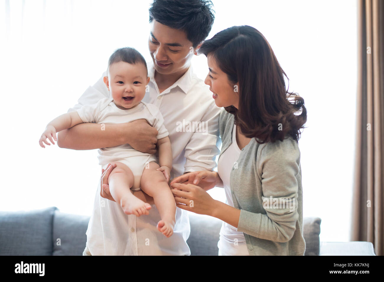 Happy young Chinese family Stock Photo - Alamy
