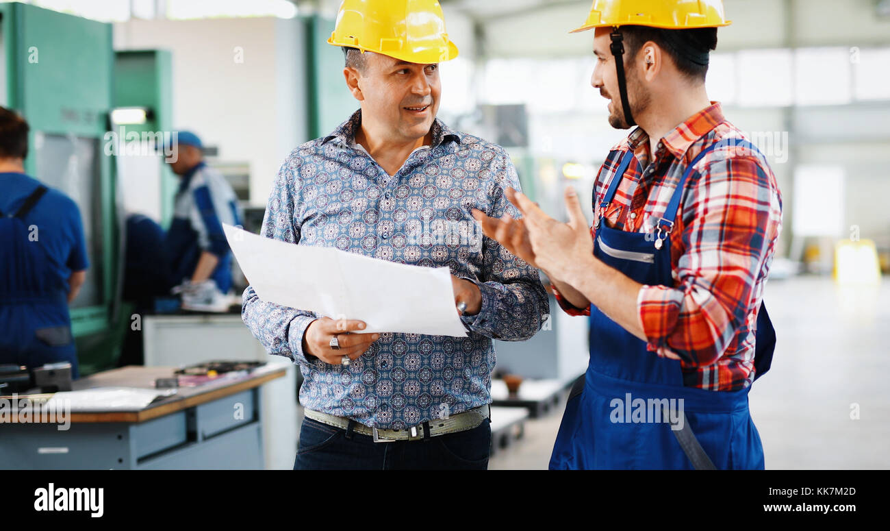 Team Of Engineers Having Discussion In Factory Stock Photo - Alamy
