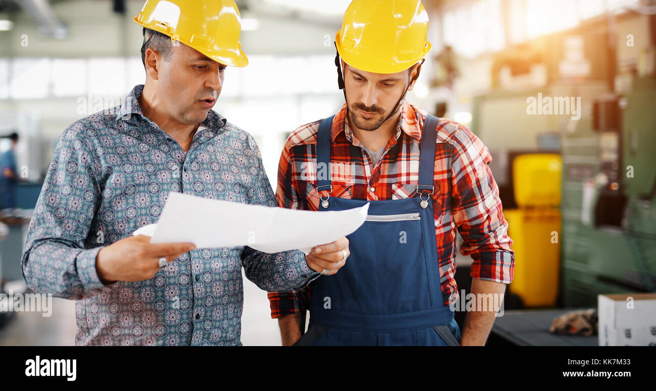 Team Of Engineers Having Discussion In Factory Stock Photo - Alamy