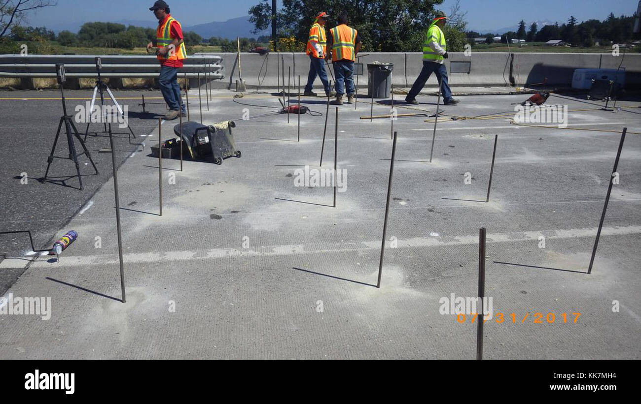 Metal rods are hammered into freshly drilled holes to help with the ...