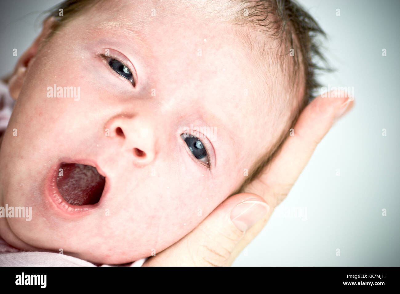 Yawning face of one month baby on mother's hand Stock Photo - Alamy