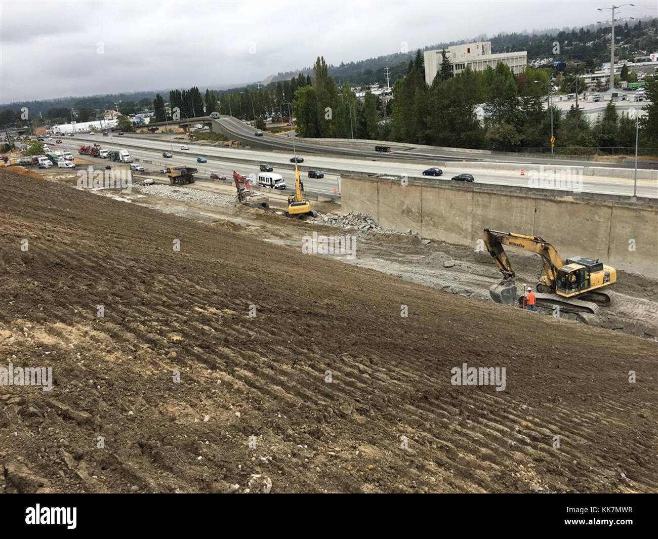 Construction crews demolish the retaining wall between the northbound I ...