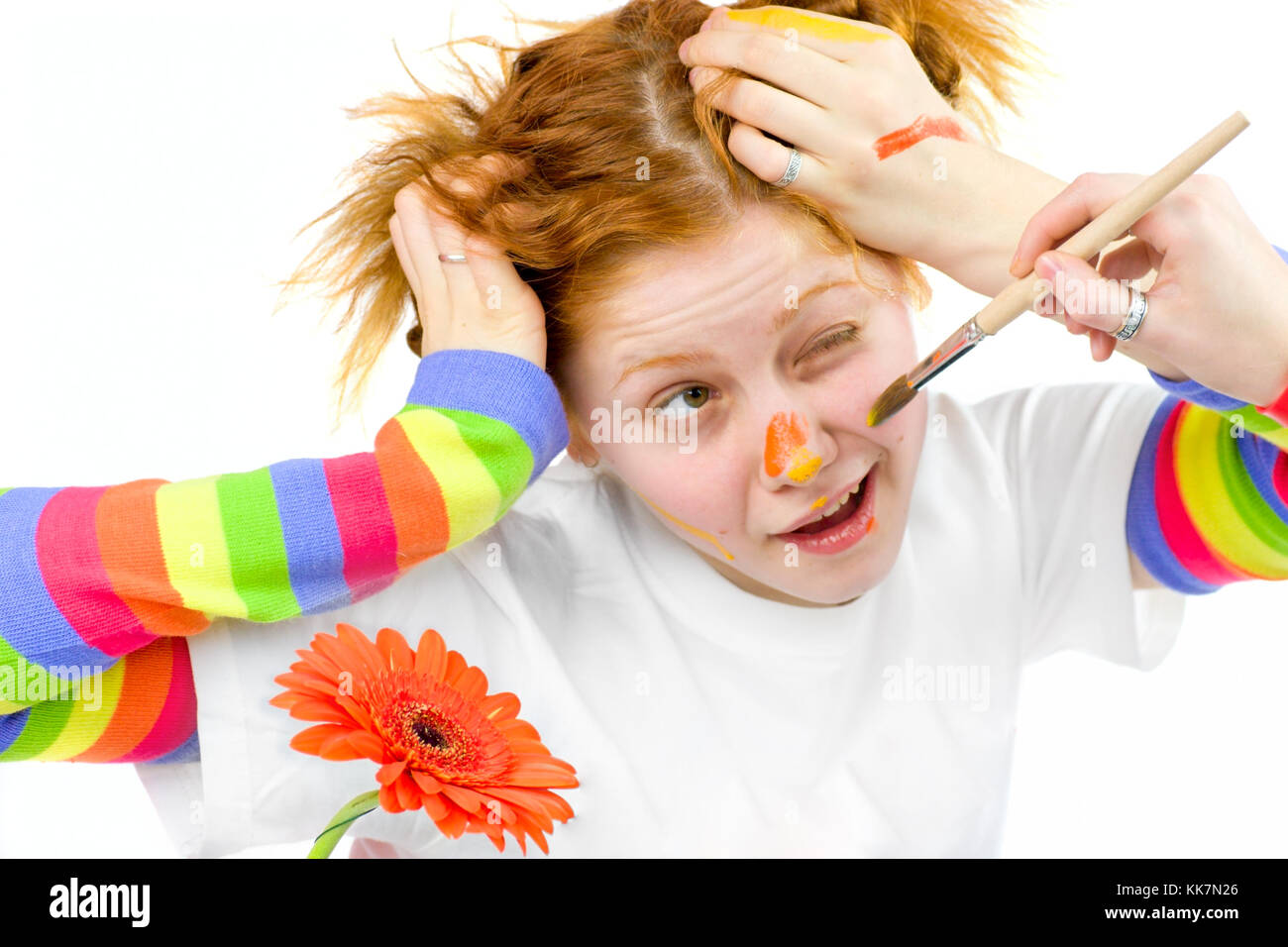 Funny artist going to paint something on friend's face Stock Photo - Alamy