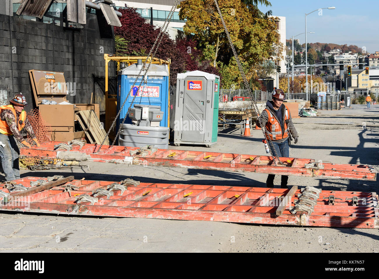 Seattle Tunnel Partners construction crews work with a crane to lower a ...