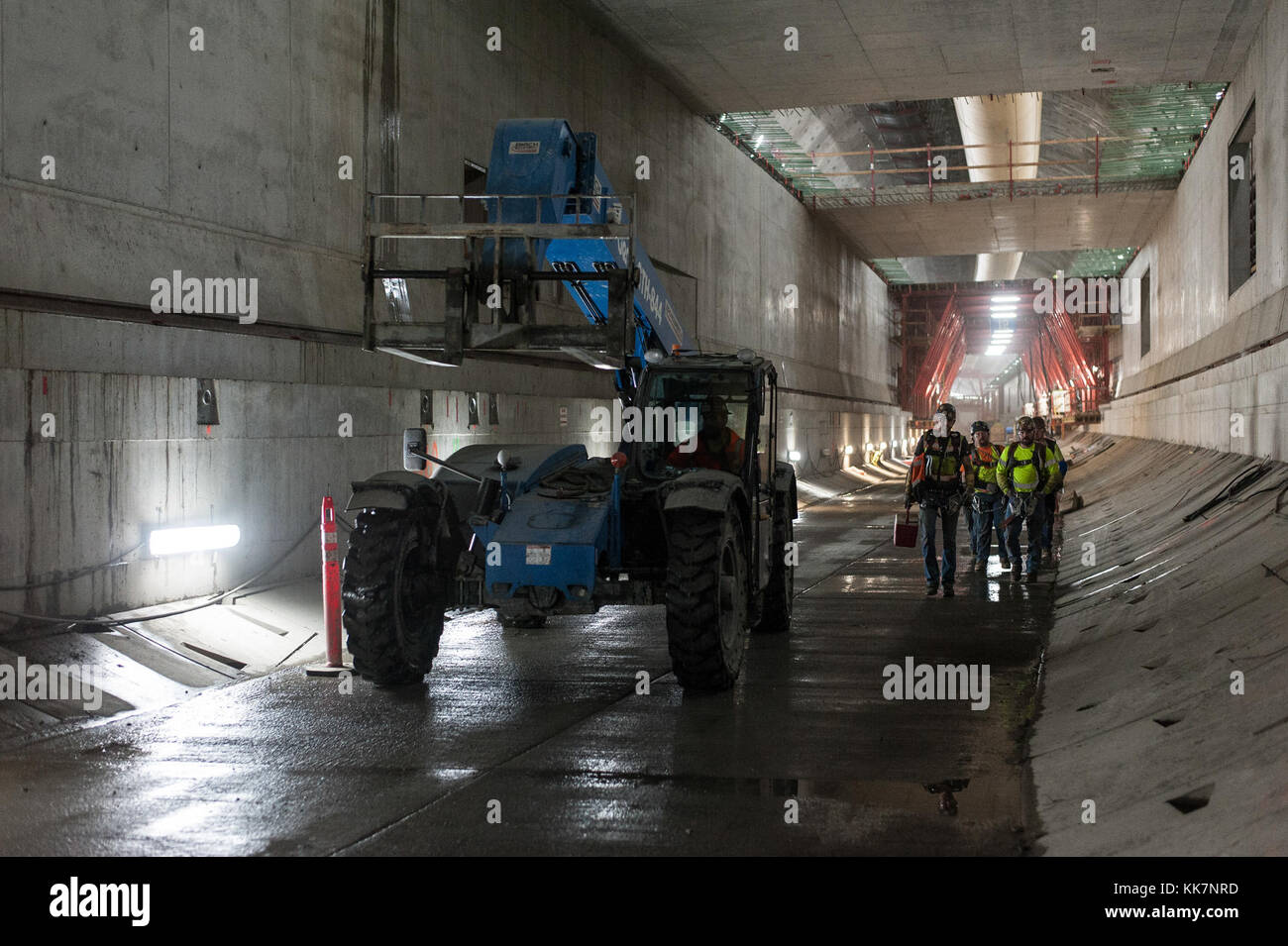 A forklift driver and a work crew on the move inside the SR 99 tunnel ...