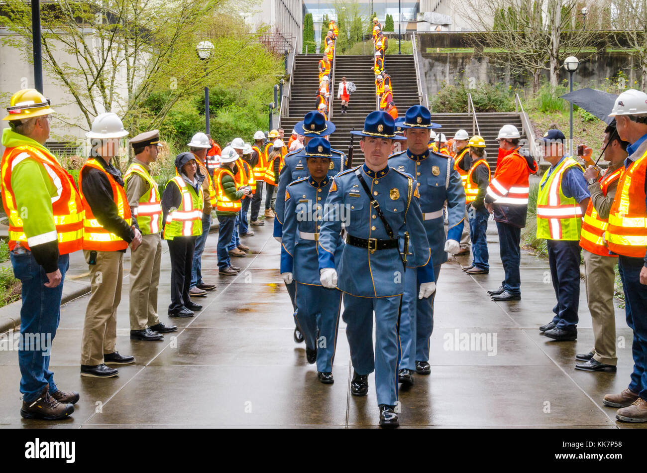 The Washington State Patrol Honor Guard leads families and workers into ...