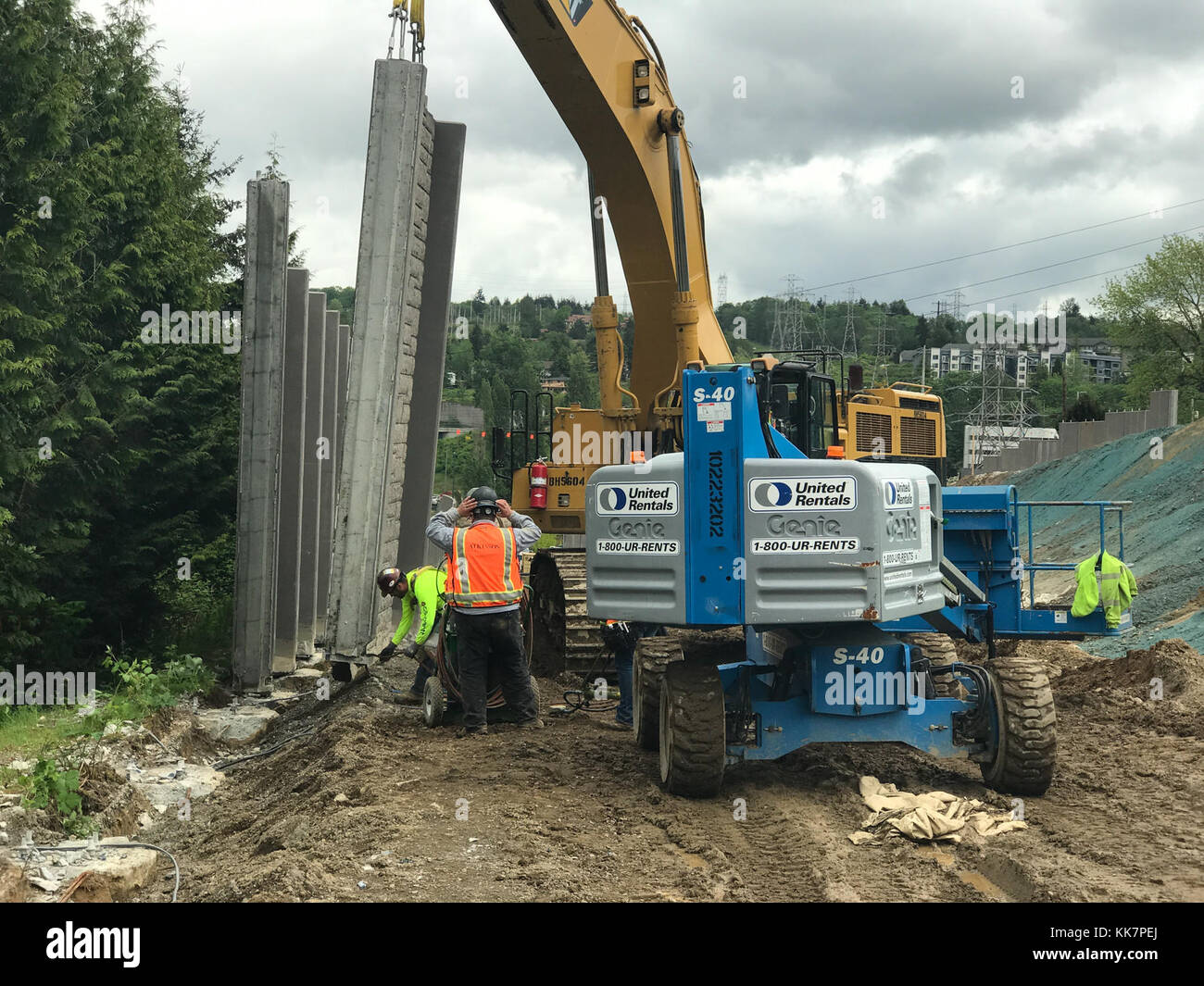 Construction crews working for WSDOT relocate a noise wall in the ...