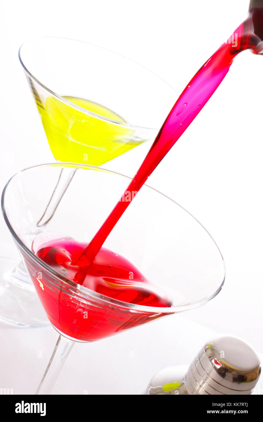 Pouring red beverage into a martini glass Stock Photo - Alamy
