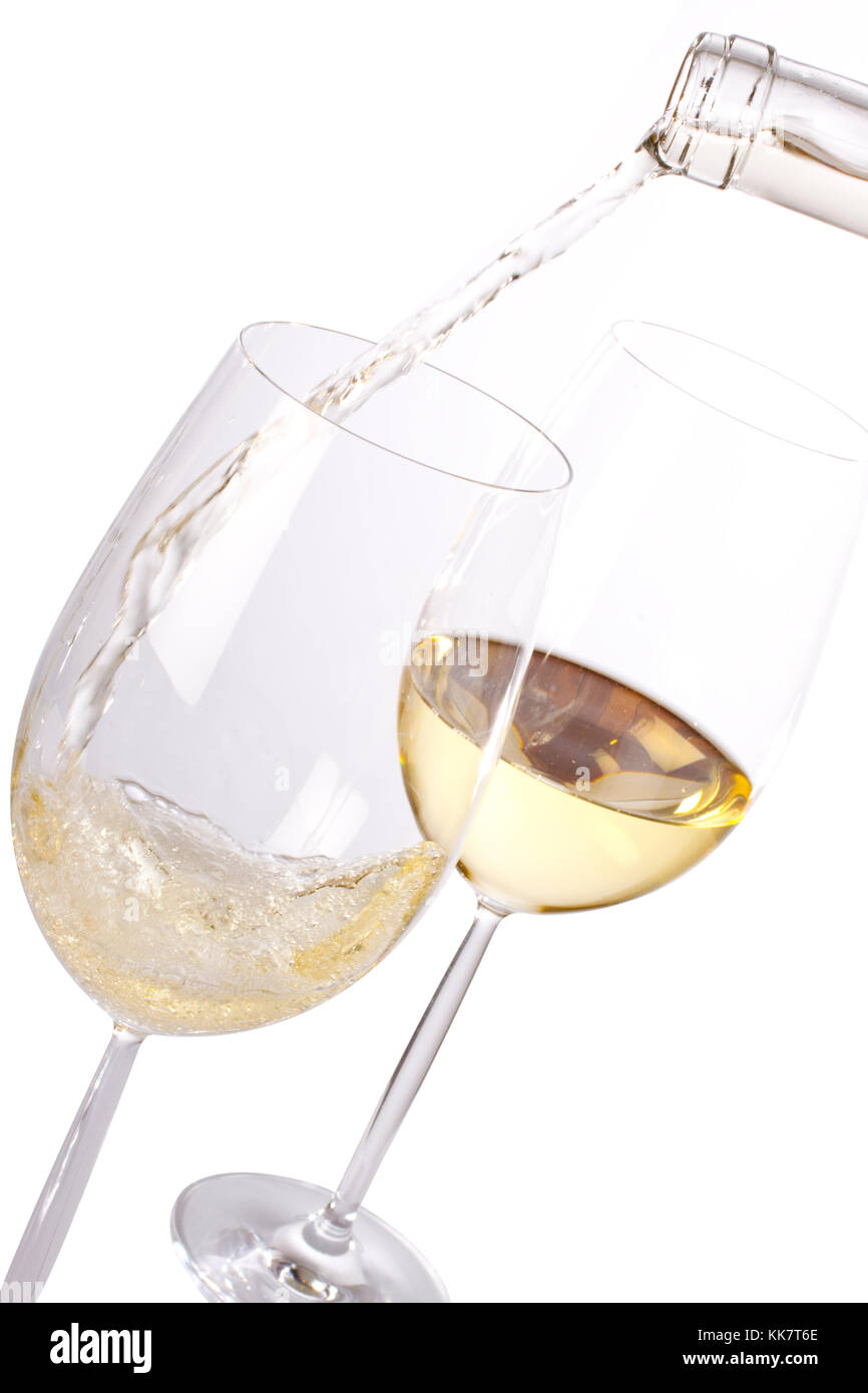 Pouring white wine into a glass and glass full at background Stock ...
