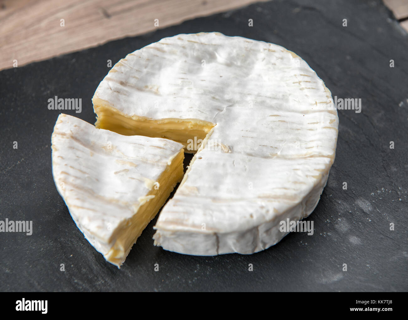 a sliced and round camembert cheese traditional Stock Photo - Alamy