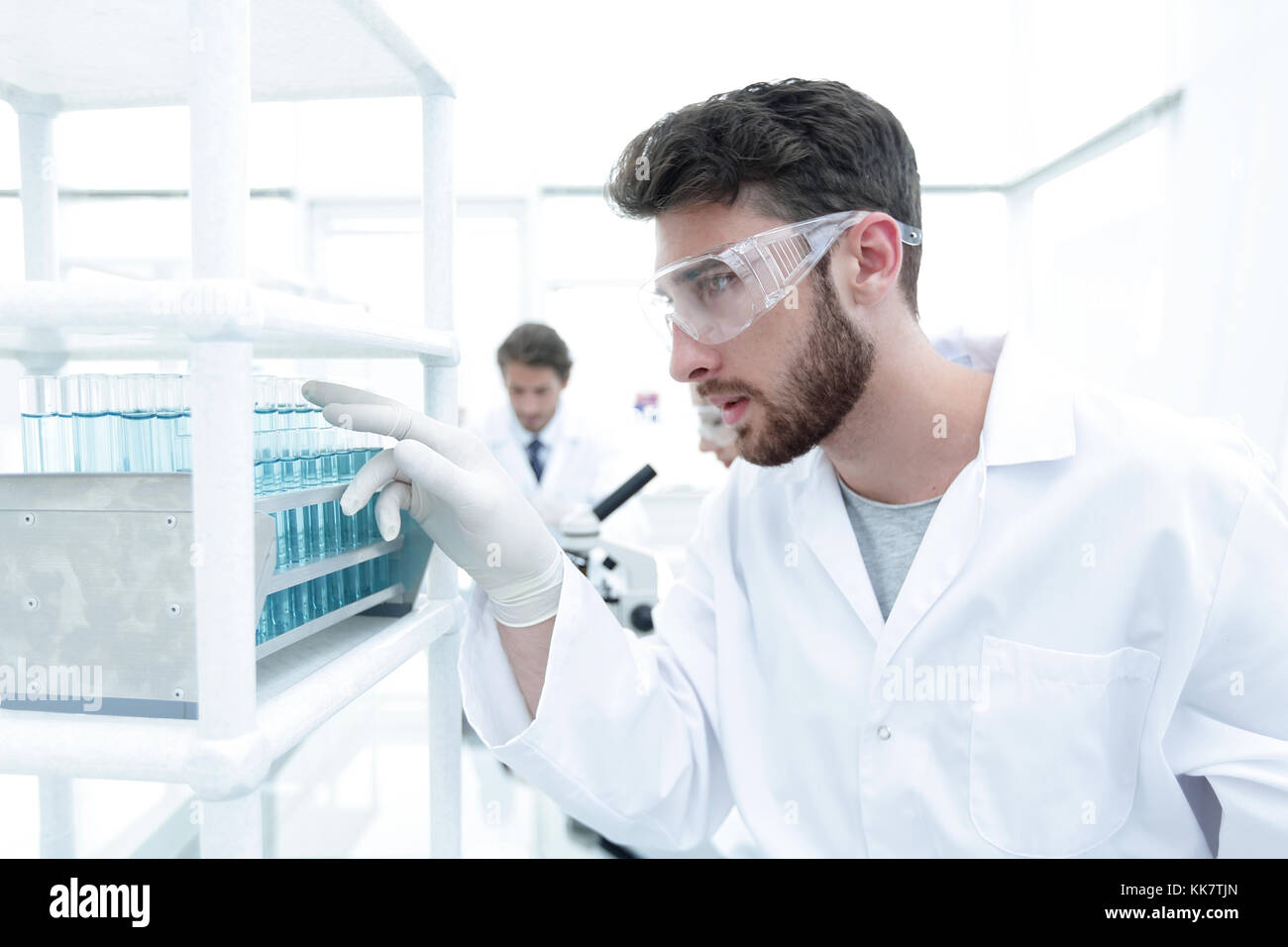 A young man doing an experiment in a chemical laboratory Stock Photo ...