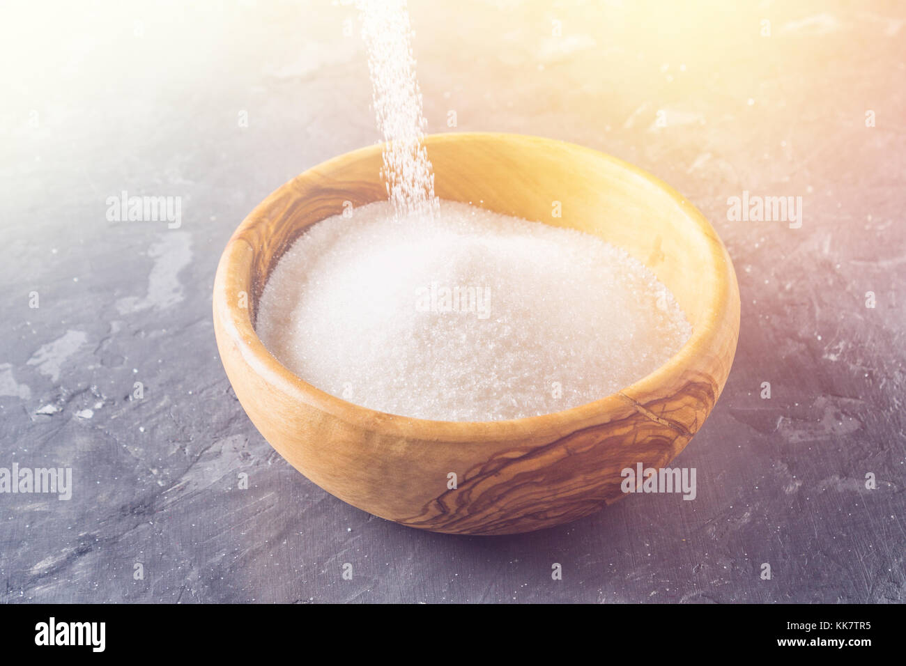 Sugar grains pouring and overflowing a bowl Stock Photo - Alamy