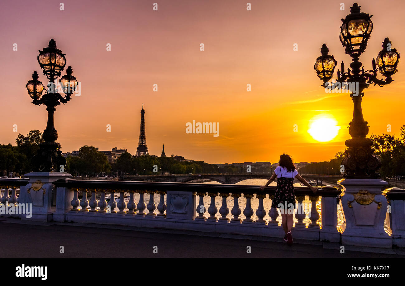 A shot from Pont Alexandre III bridge at sunset looking towards the ...