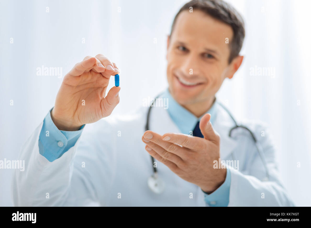 Cheerful male person pointing at tablet Stock Photo - Alamy