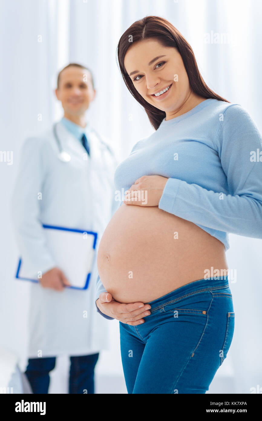 Pregnant woman showing belly camera hi-res stock photography and images ...