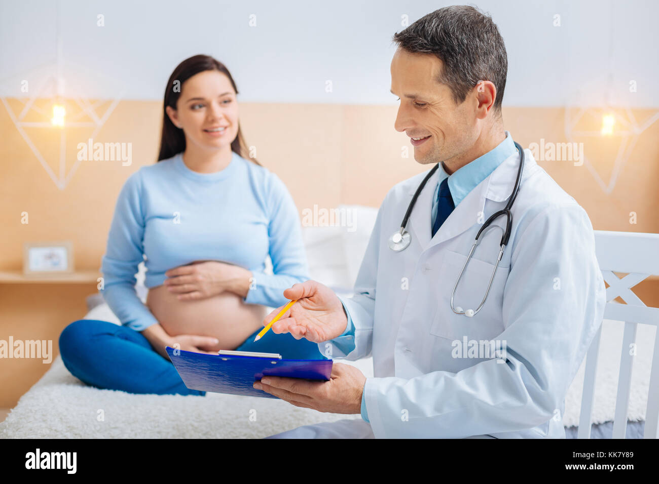 Competent doctor giving useful recommendations Stock Photo - Alamy