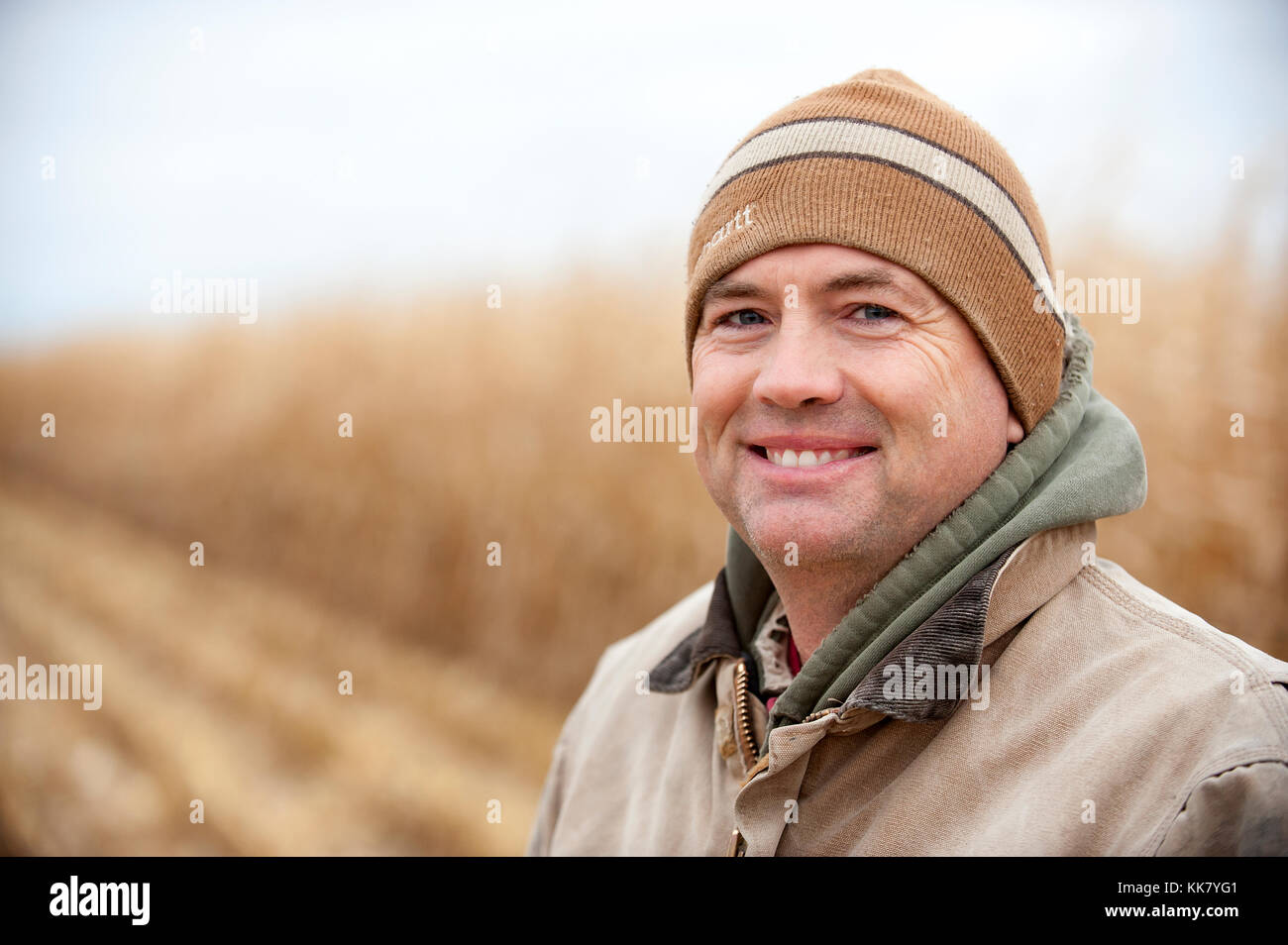 PORTRAIT OF A FARMER FARMER IN CORN FIELD BLOOMING PRAIRIE, MINNESOTA ...