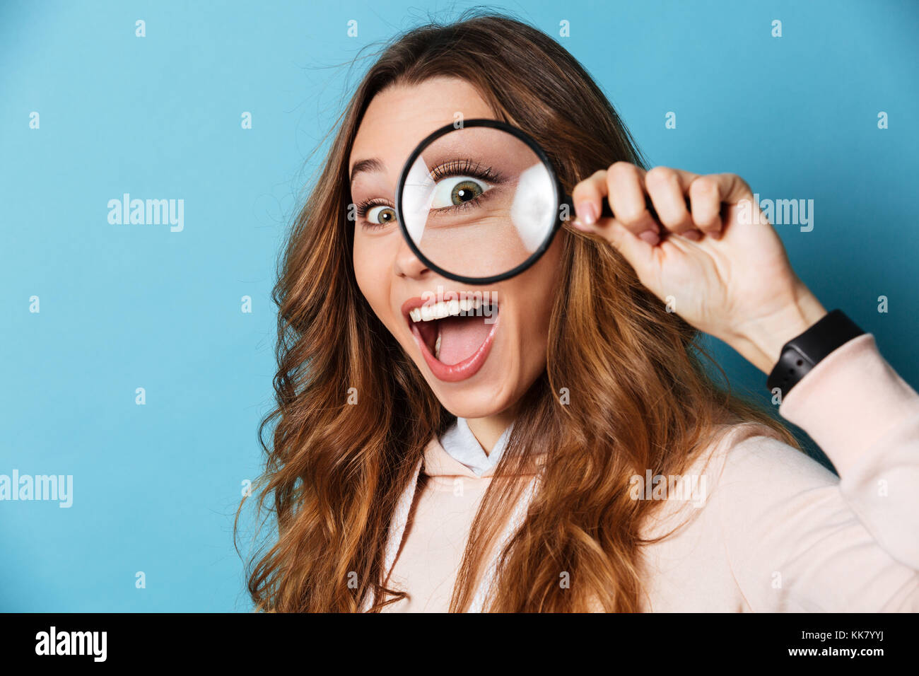 Close up portrait of a cheerful pretty girl looking through magnifying ... Close up portrait of a cheerful pretty girl looking through magnifying ...