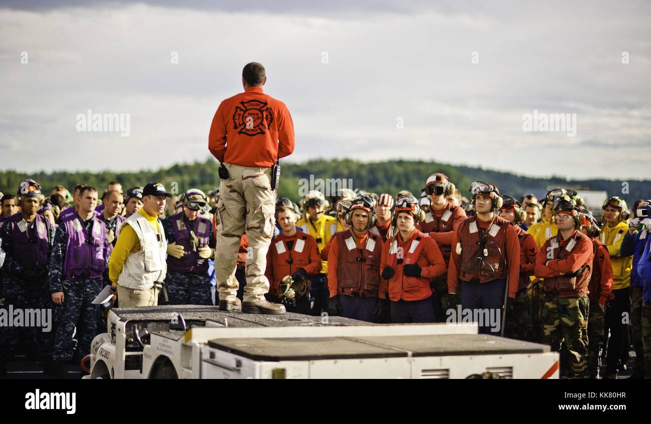 Ensign Mark Rodriguez briefs Sailors prior to flight deck fire fighting ...