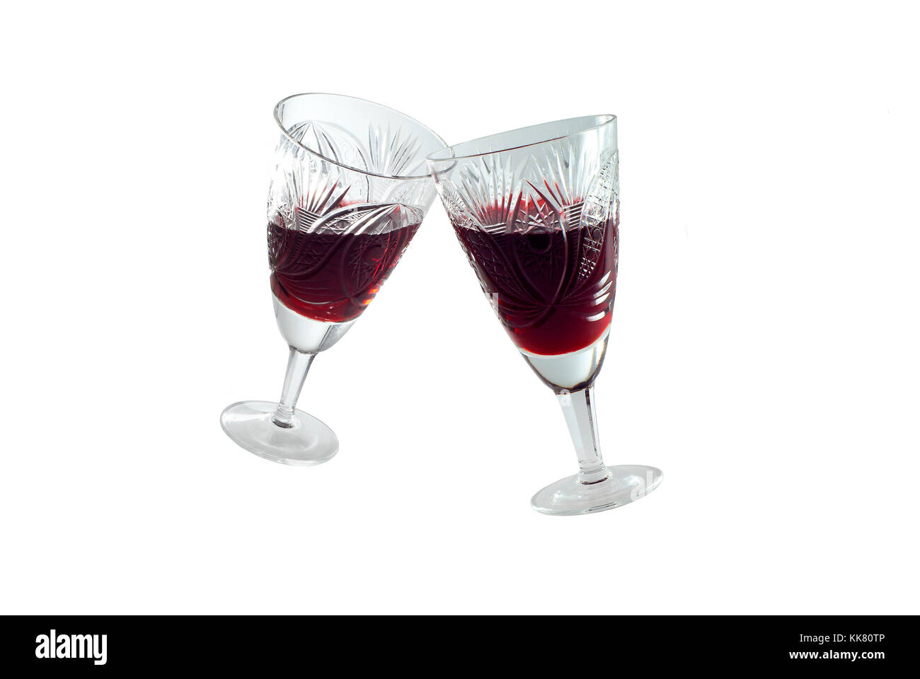 clinking vintage faceted crystal glasses (no hands) with red wine ...