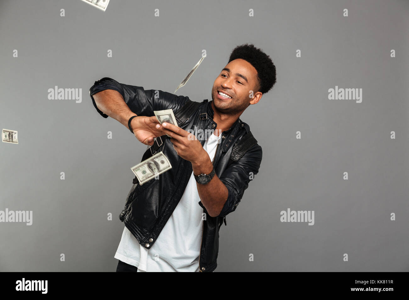 Funny afro american rich man scattering dollars banknotes, isolated ...