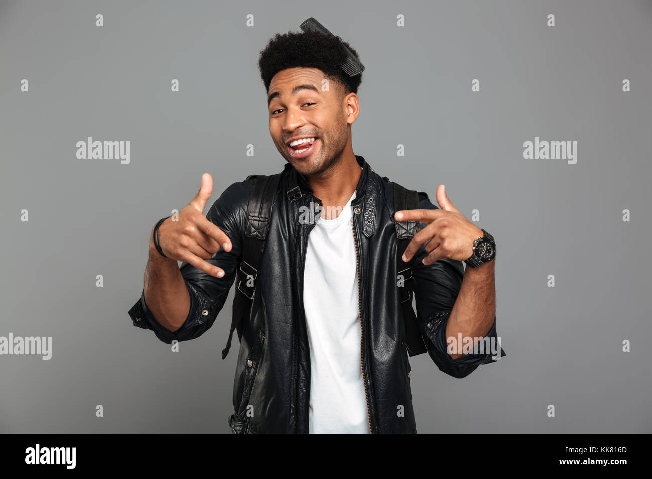 Portrait of a funny afro american man in leather jacket posing while ...