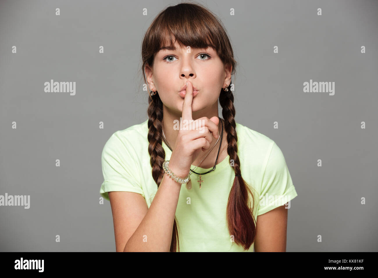 Photo of pretty girl jumping isolated grey background. Looking camera ...