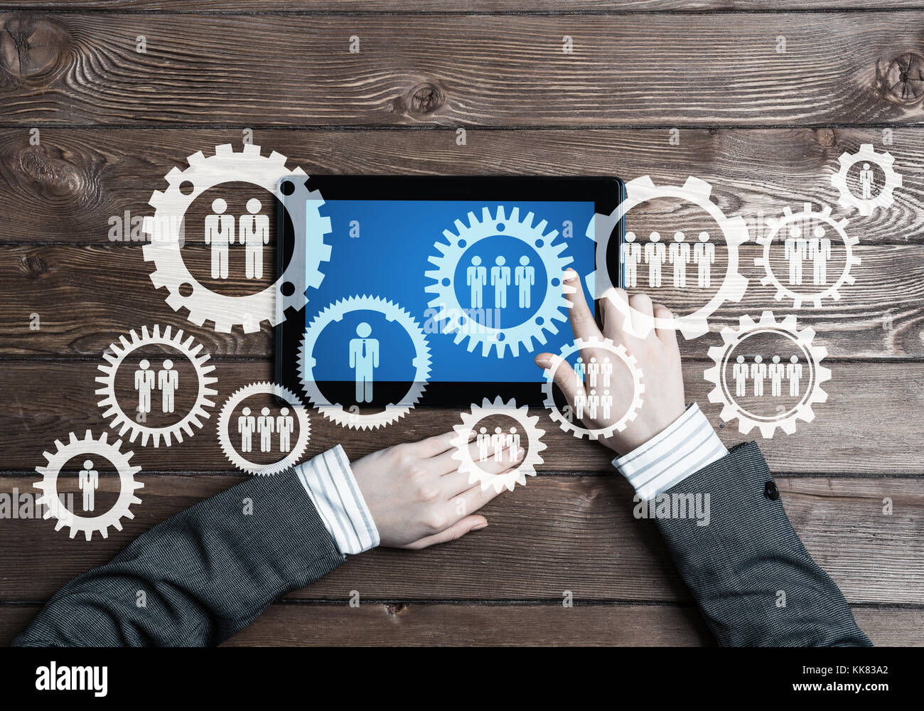 Concept of teamworking and connection with gears mechanism and tablet ...
