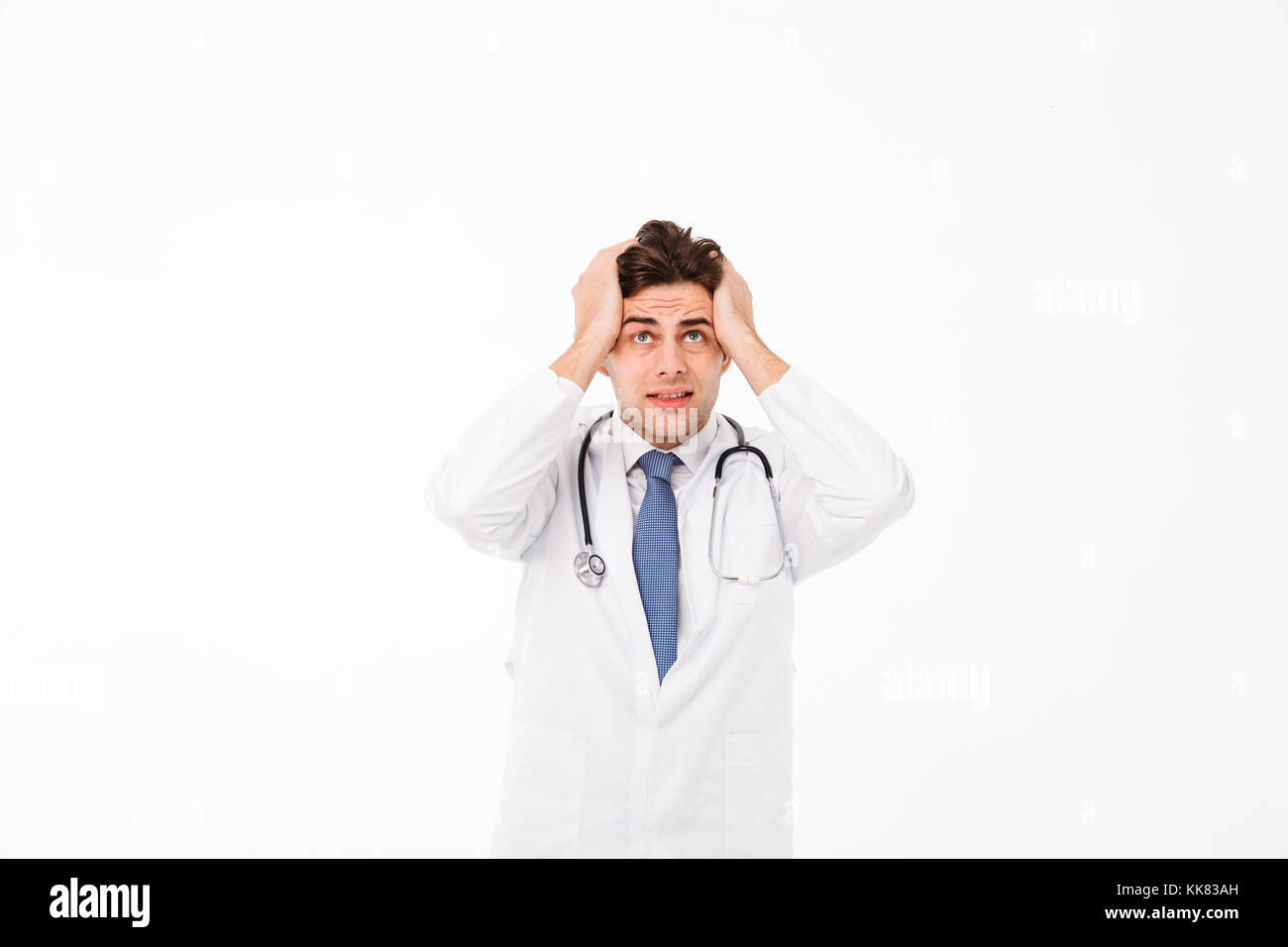Portrait of a confused worried young male doctor with stethoscope ...