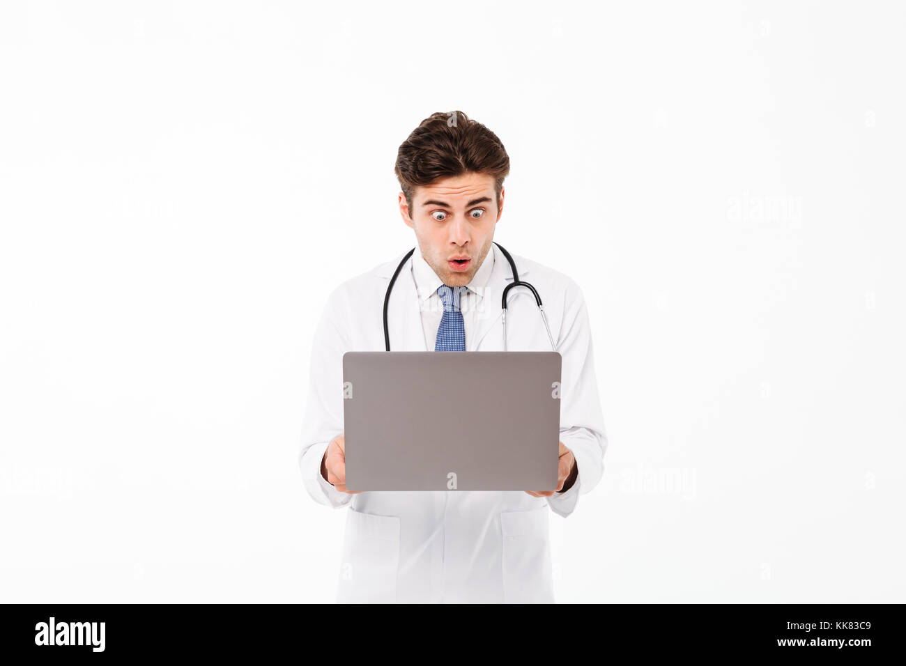 Portrait of a shocked male doctor with stethoscope dressed in uniform ...