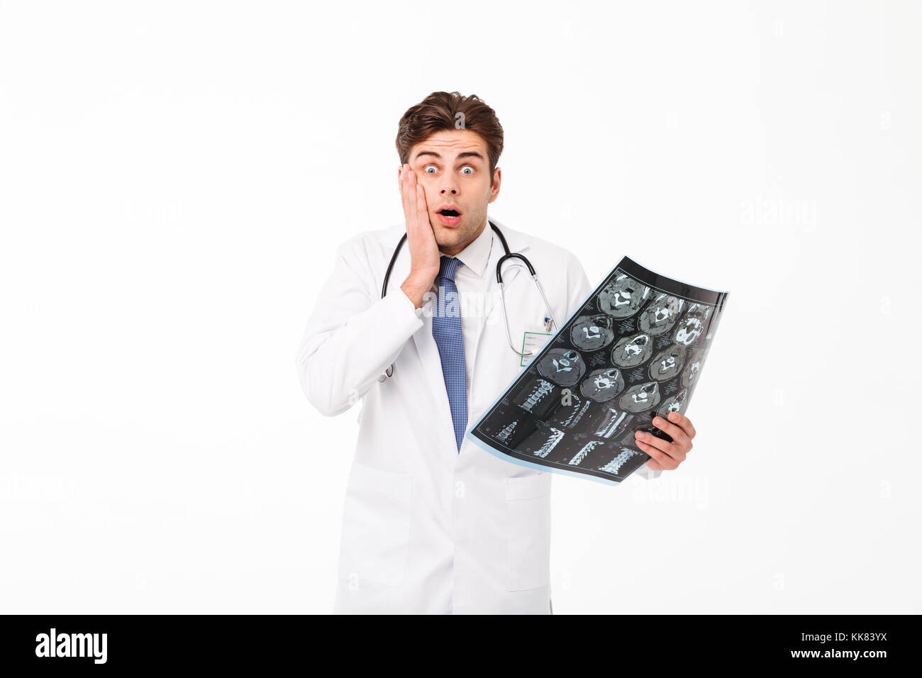 Portrait of a shocked young male doctor with stethoscope dressed in ...