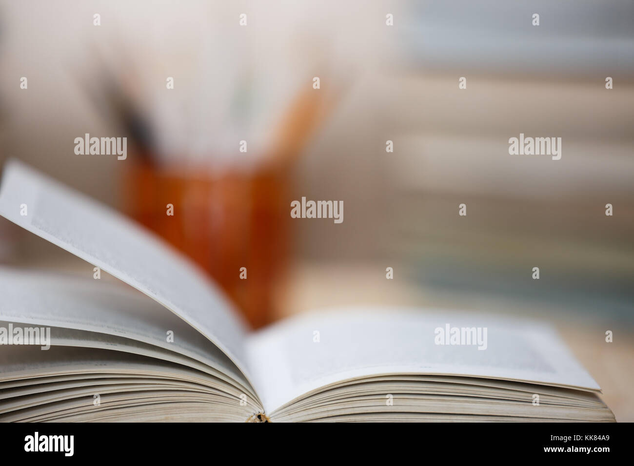 Open textbooks on wood desk with blurred focus for education background ...