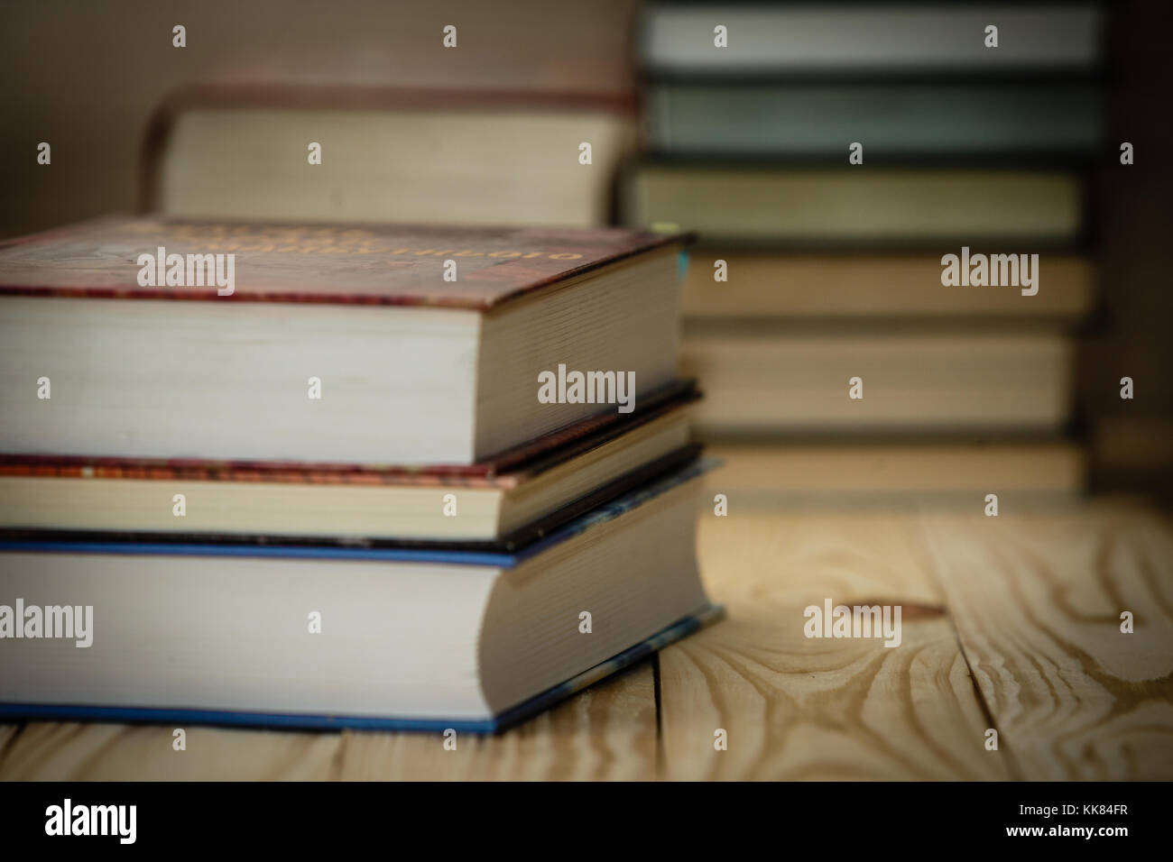 Textbooks and books on a wooden table. Book stack in the library room ...