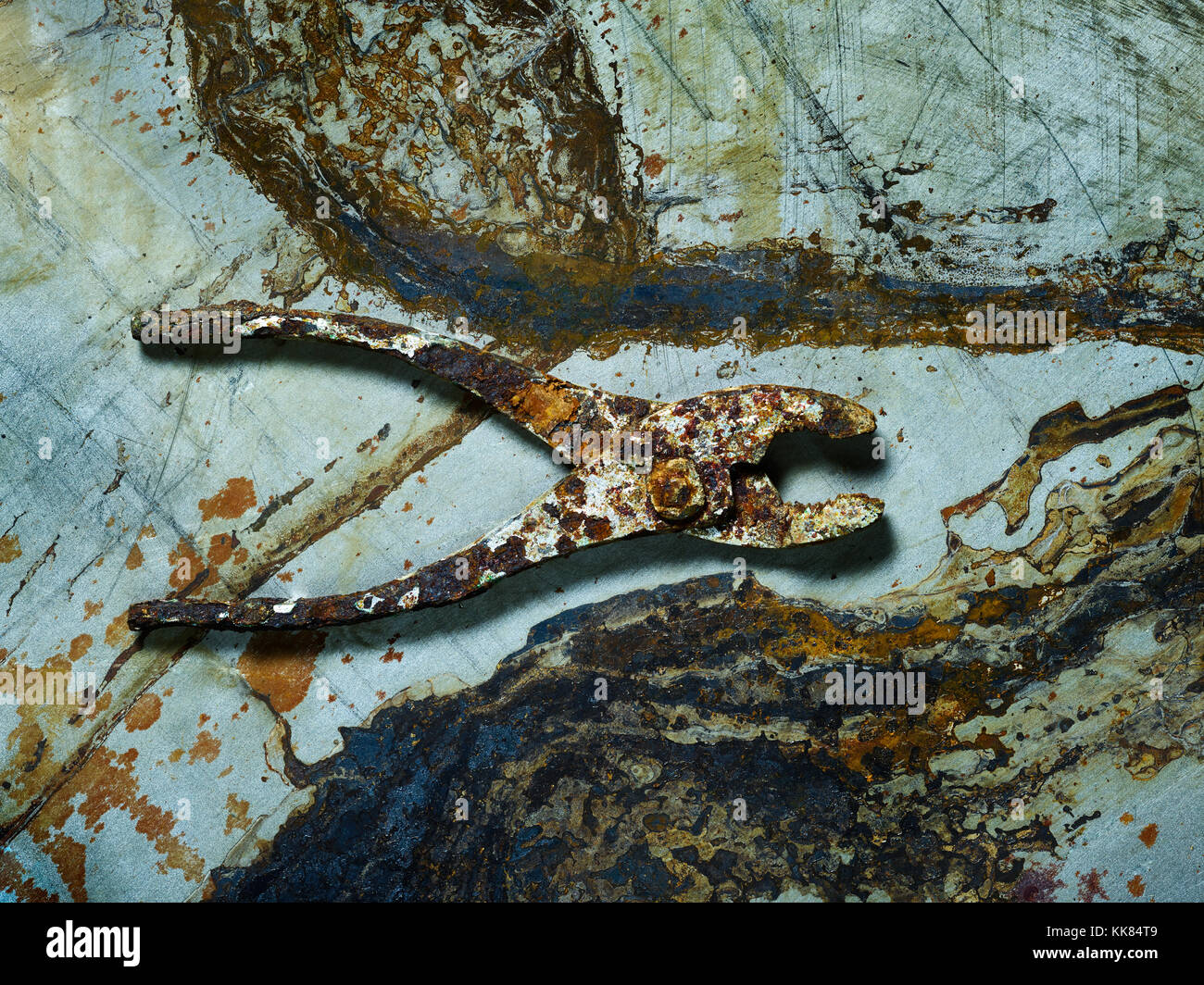 Rusty corroded pliers on rusty metal surface Stock Photo - Alamy