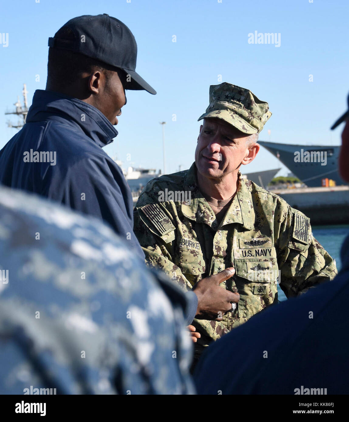 Chief of Naval Personnel Vice Adm. Robert Burke, right, speaks with USS ...