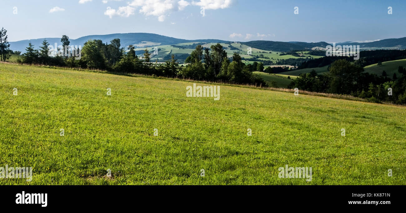mountain countryside with meadows, fields, villages, trees, hills and ...
