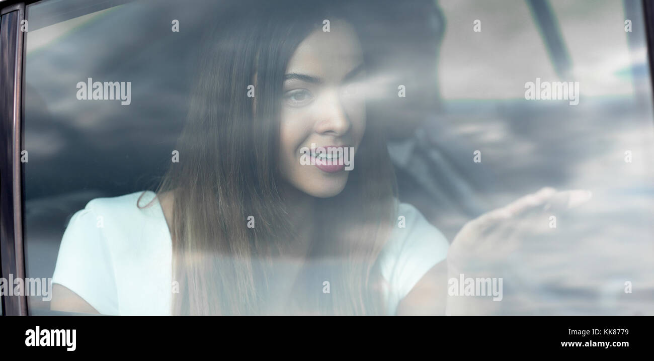 young woman portrait in the car behind the window Stock Photo - Alamy