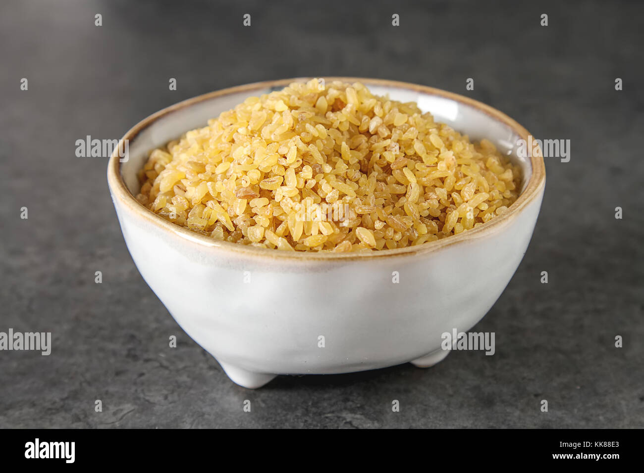 Bulgur on a dark background. Vegetarian Oriental food Stock Photo - Alamy