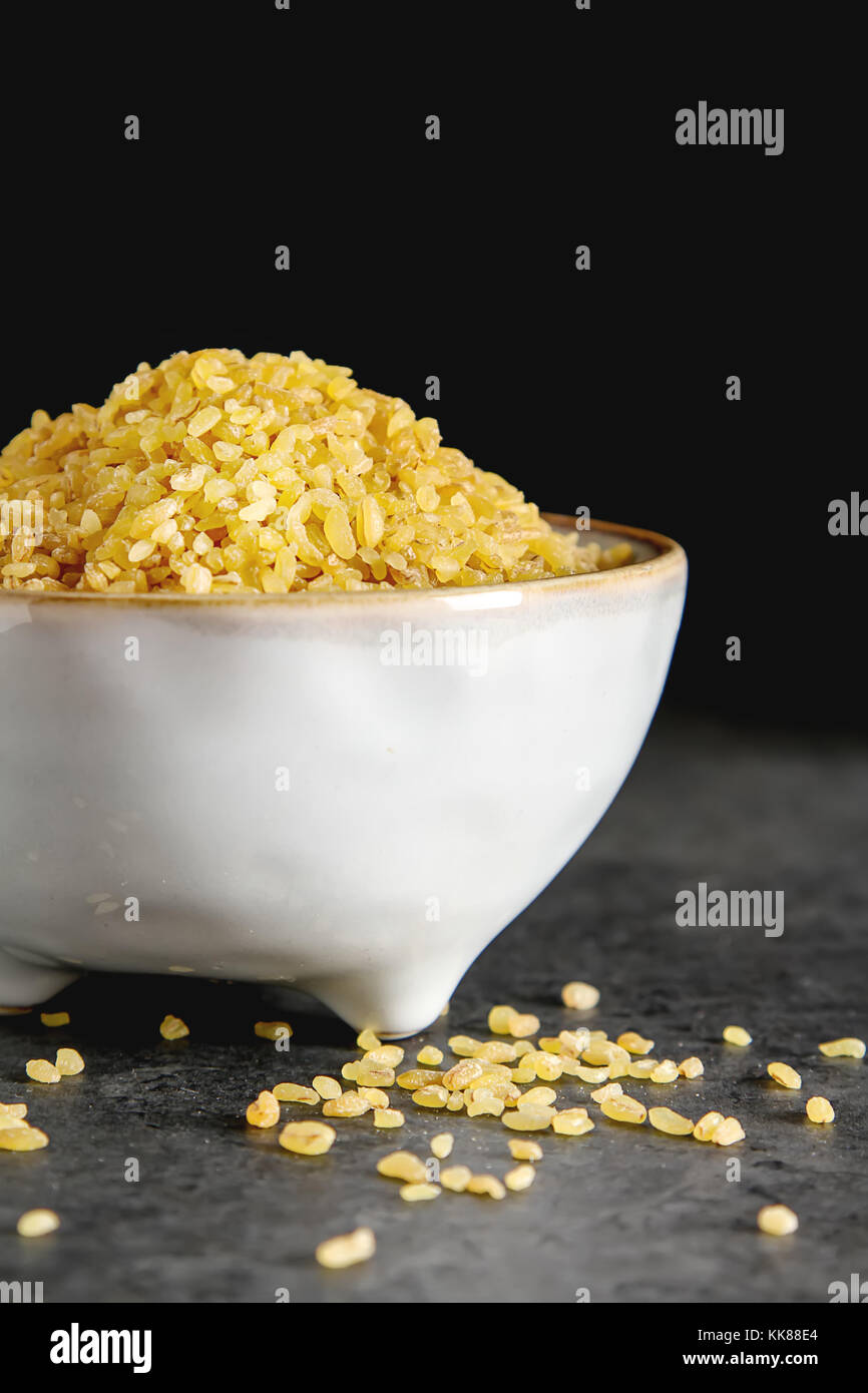 Bulgur on a dark background. Vegetarian Oriental food Stock Photo - Alamy
