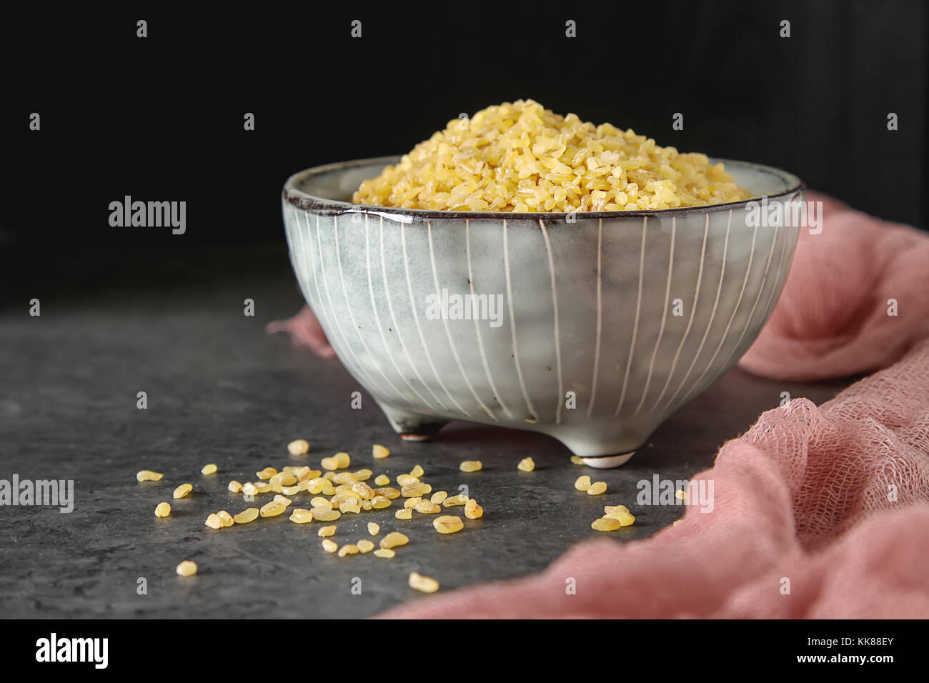 Bulgur on a dark background. Vegetarian Oriental food Stock Photo - Alamy