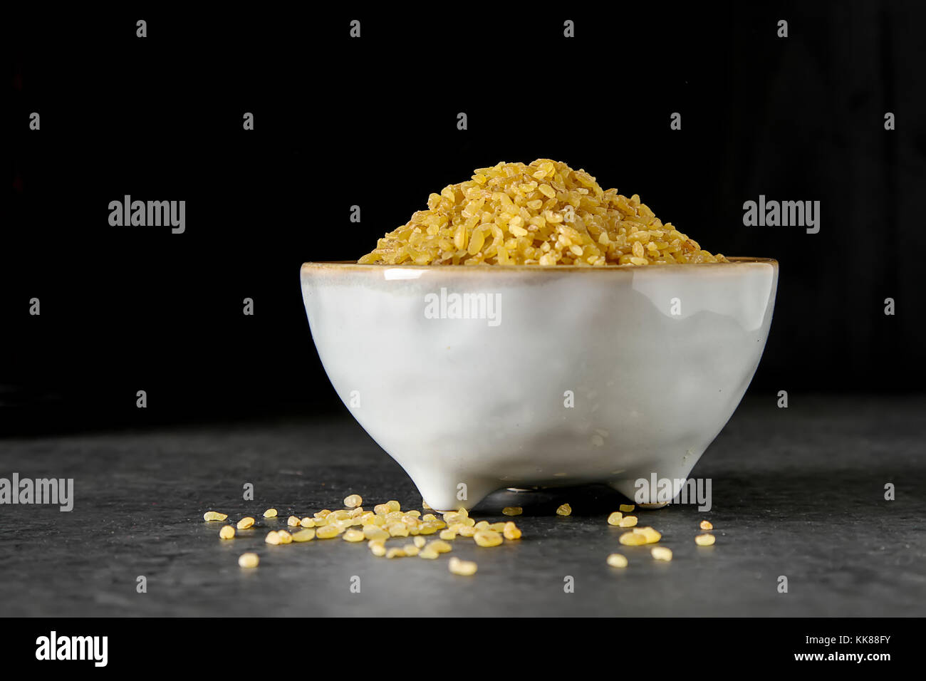 Bulgur on a dark background. Vegetarian Oriental food Stock Photo - Alamy