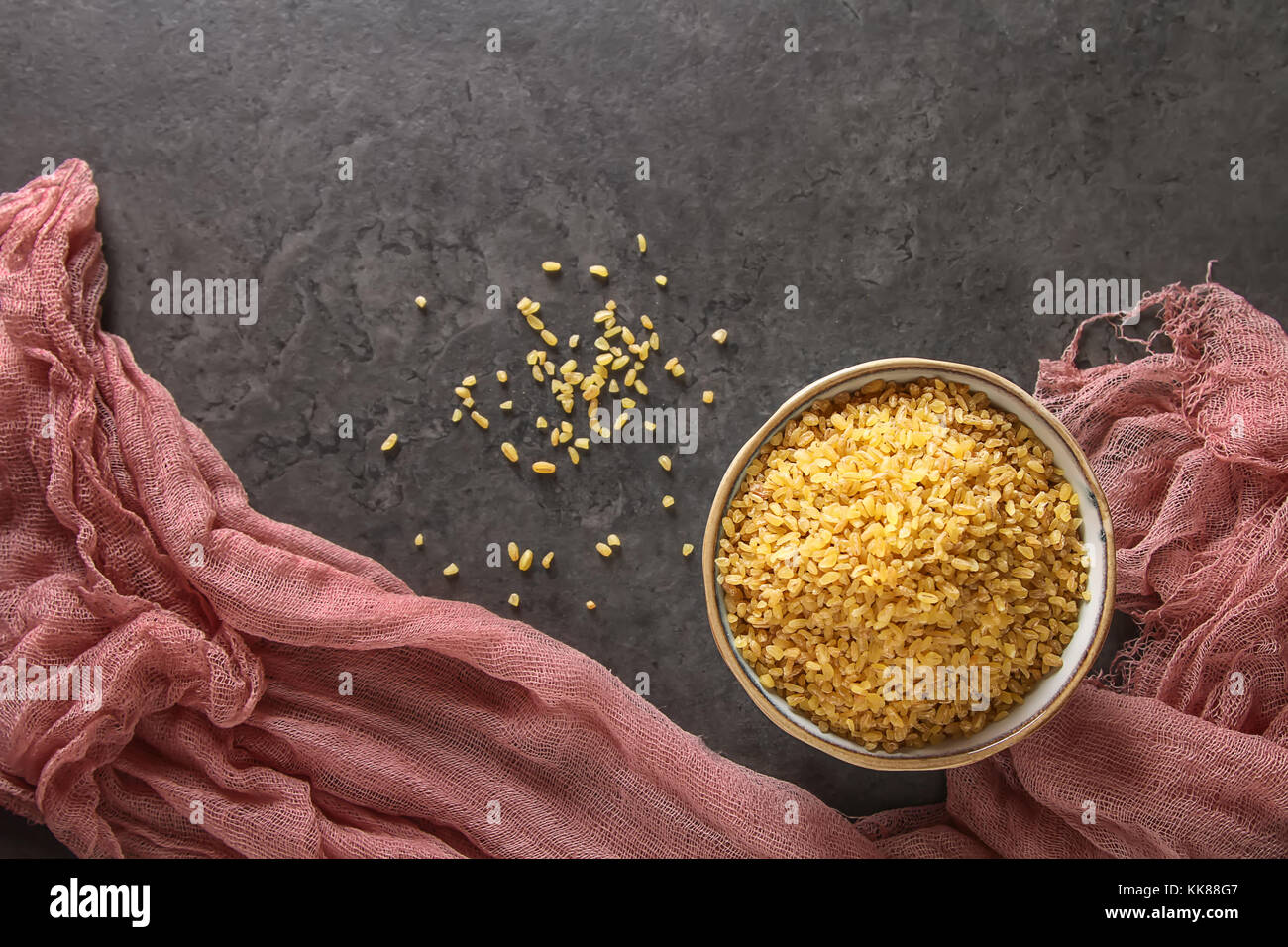 Bulgur on a dark background. Vegetarian Oriental food Stock Photo - Alamy