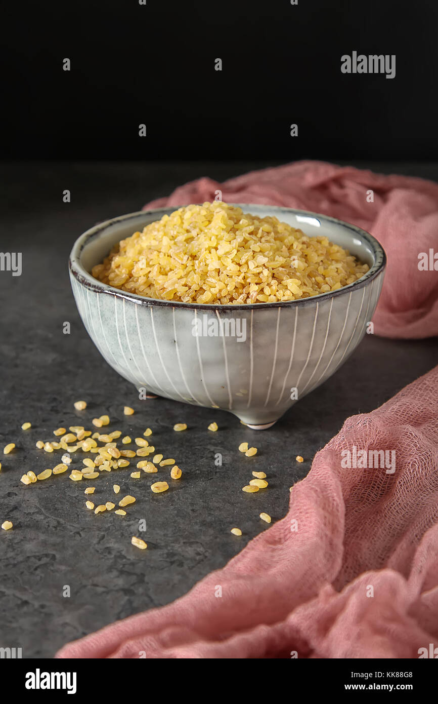 Bulgur on a dark background. Vegetarian Oriental food Stock Photo - Alamy