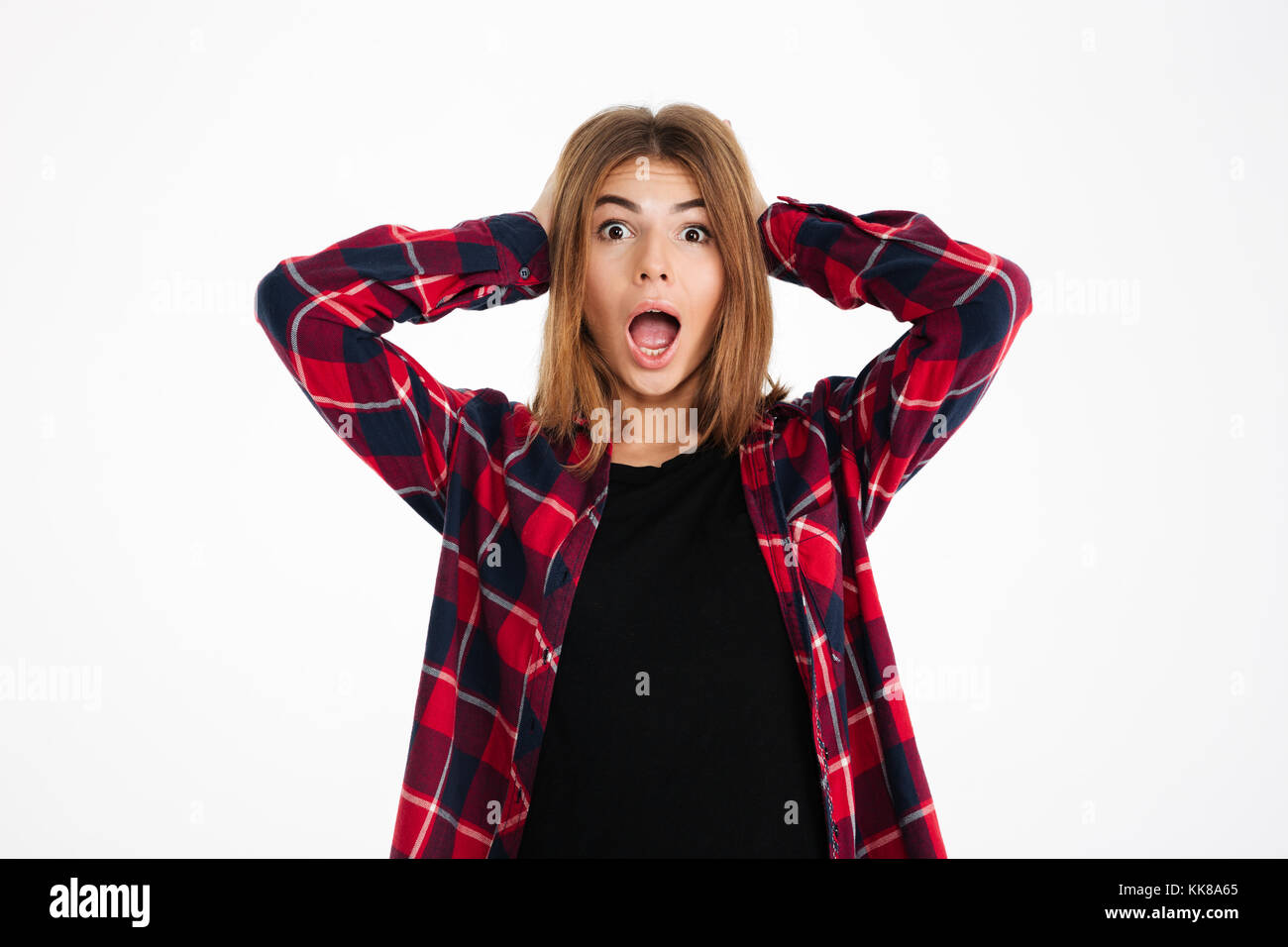 Photo of shocked young woman standing isolated over white wall ...