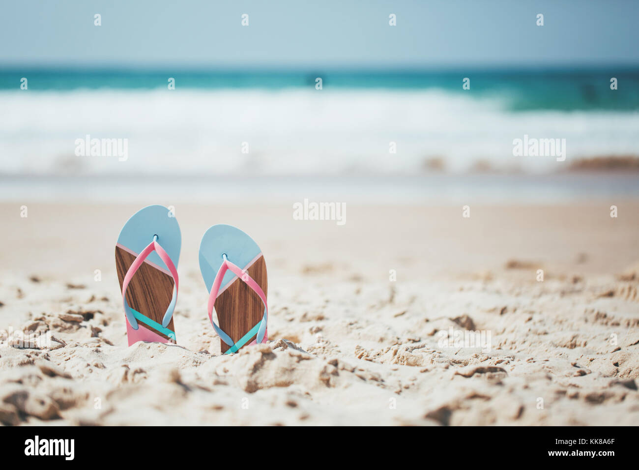 Trendy slippers on the sandy beach Stock Photo - Alamy