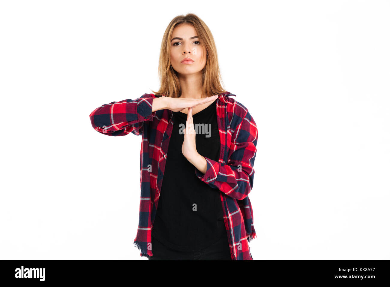 Image of serious young woman standing isolated over white wall ...