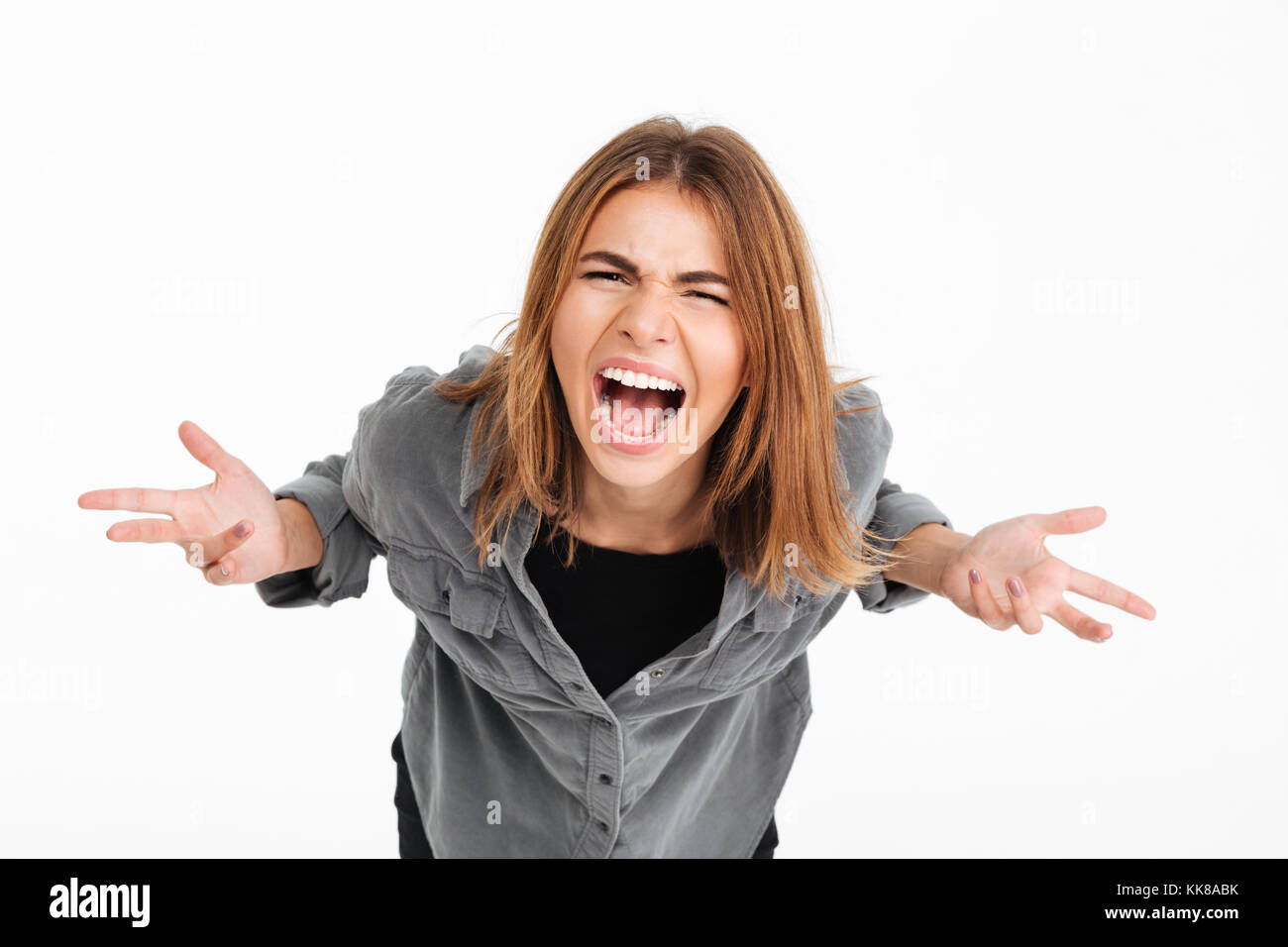 Close up portrait of a mad upset girl shouting while looking at camera ...