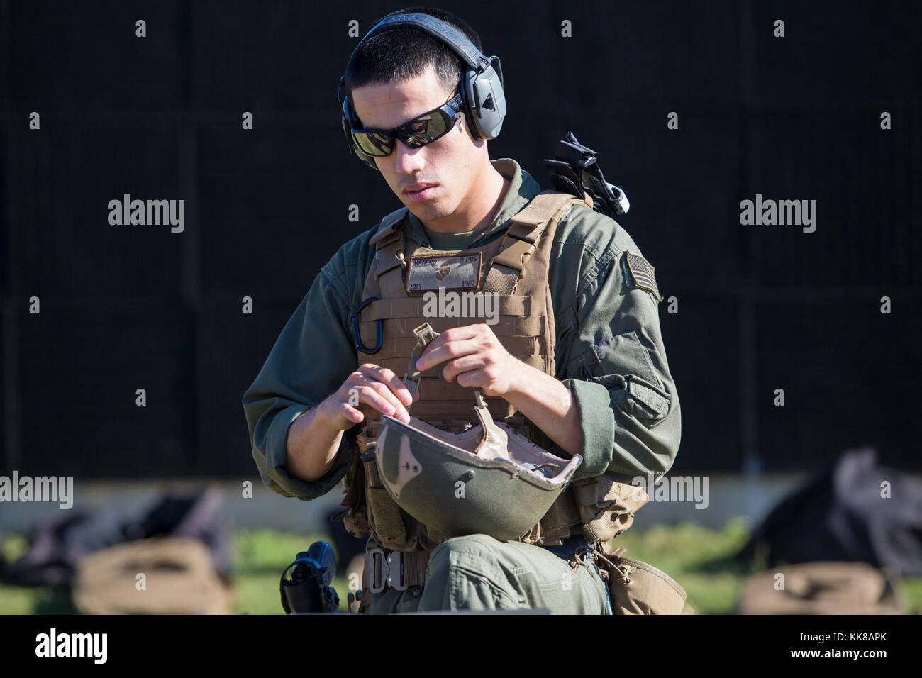 CAMP HANSEN, OKINAWA, Japan – Cpl. Giomar Medero tightens the strap to ...